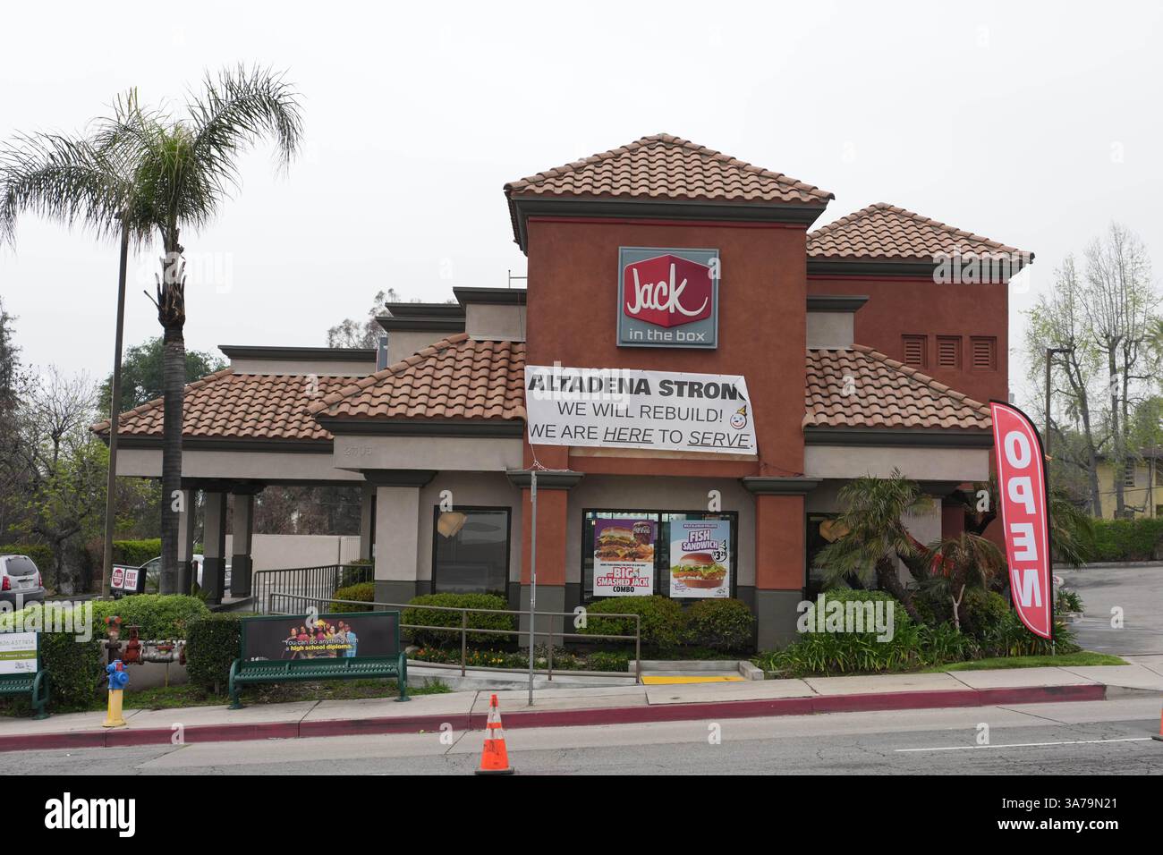 An Altadena Strong-We Will Rebuild banner at a Jack in the Box ...