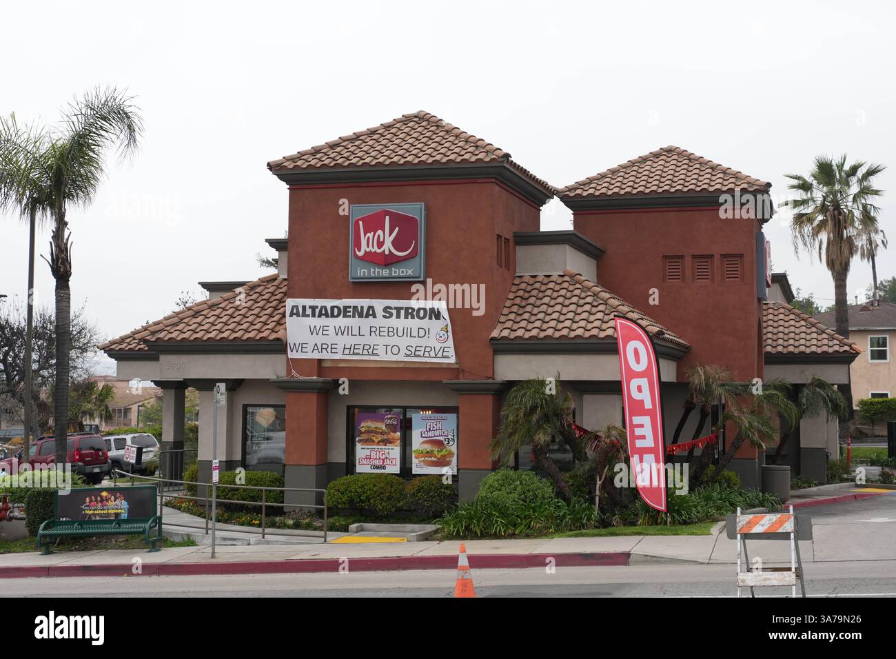 An Altadena Strong-We Will Rebuild banner at a Jack in the Box ...