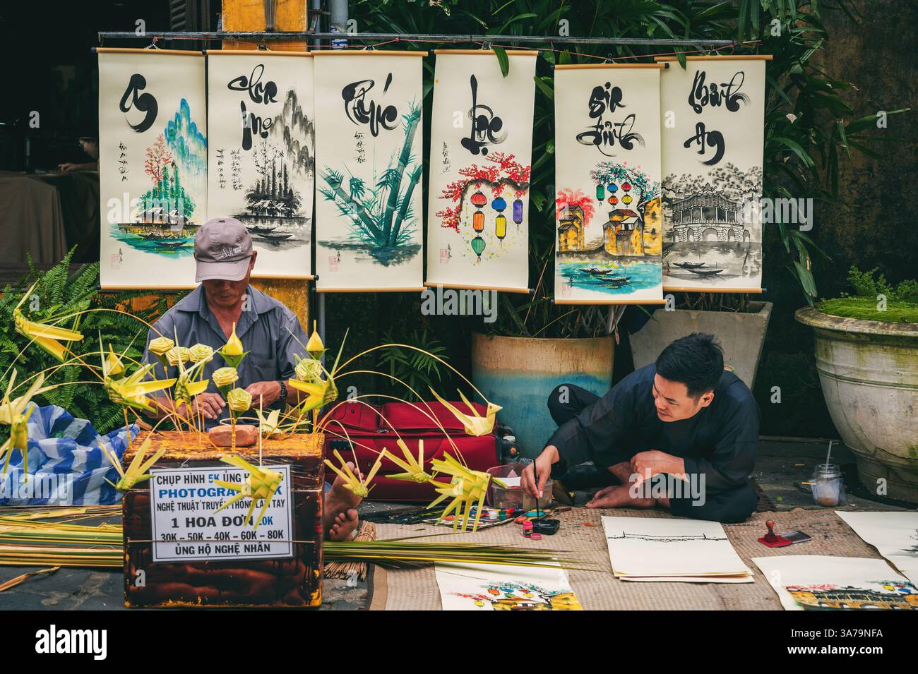 Asian men Vietnamese street artist painter and artisan craftsman work ...