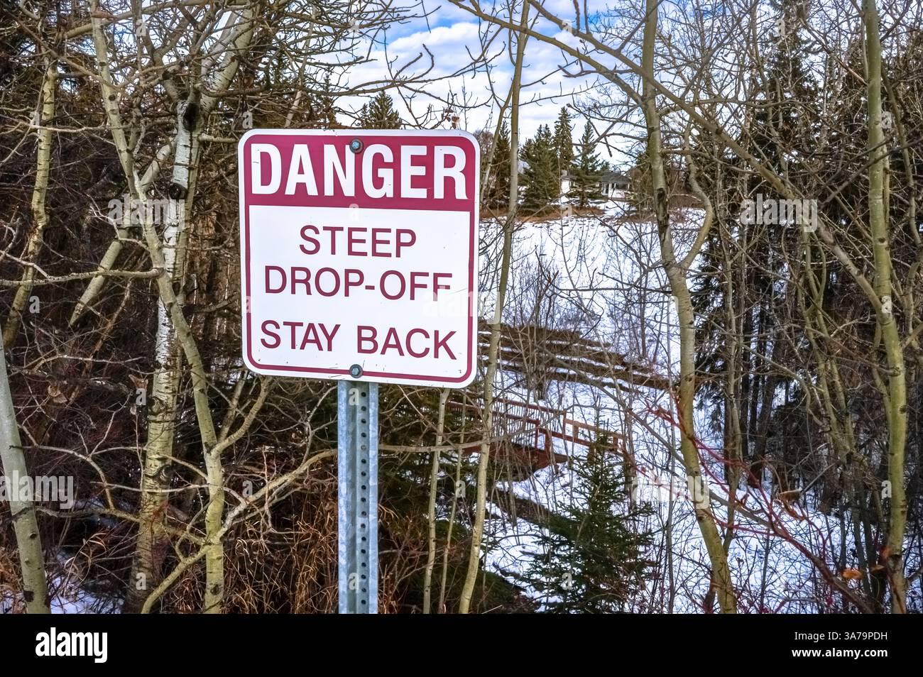 Warning sign - danger, steep drop-off with background of city park ...
