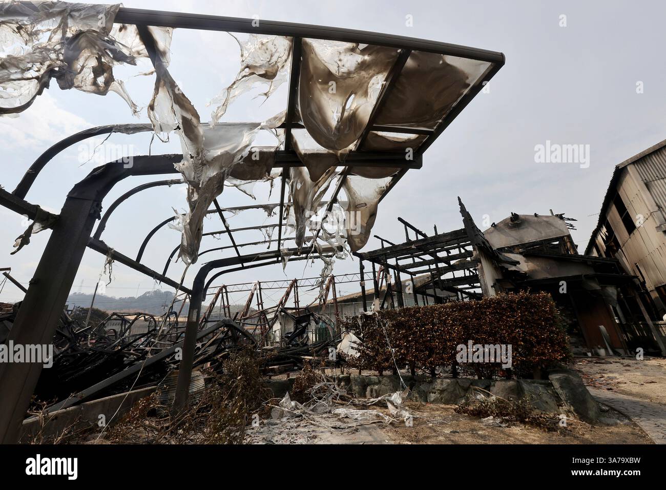 A photo shows a building completely burned down due to the spread of a ...