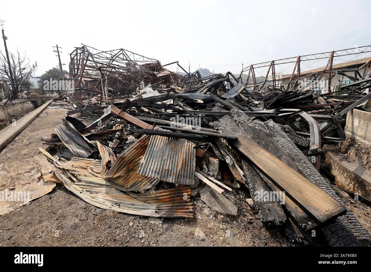 A photo shows a building completely burned down due to the spread of a ...