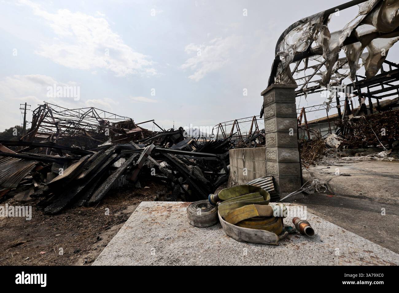 A photo shows a building completely burned down due to the spread of a ...