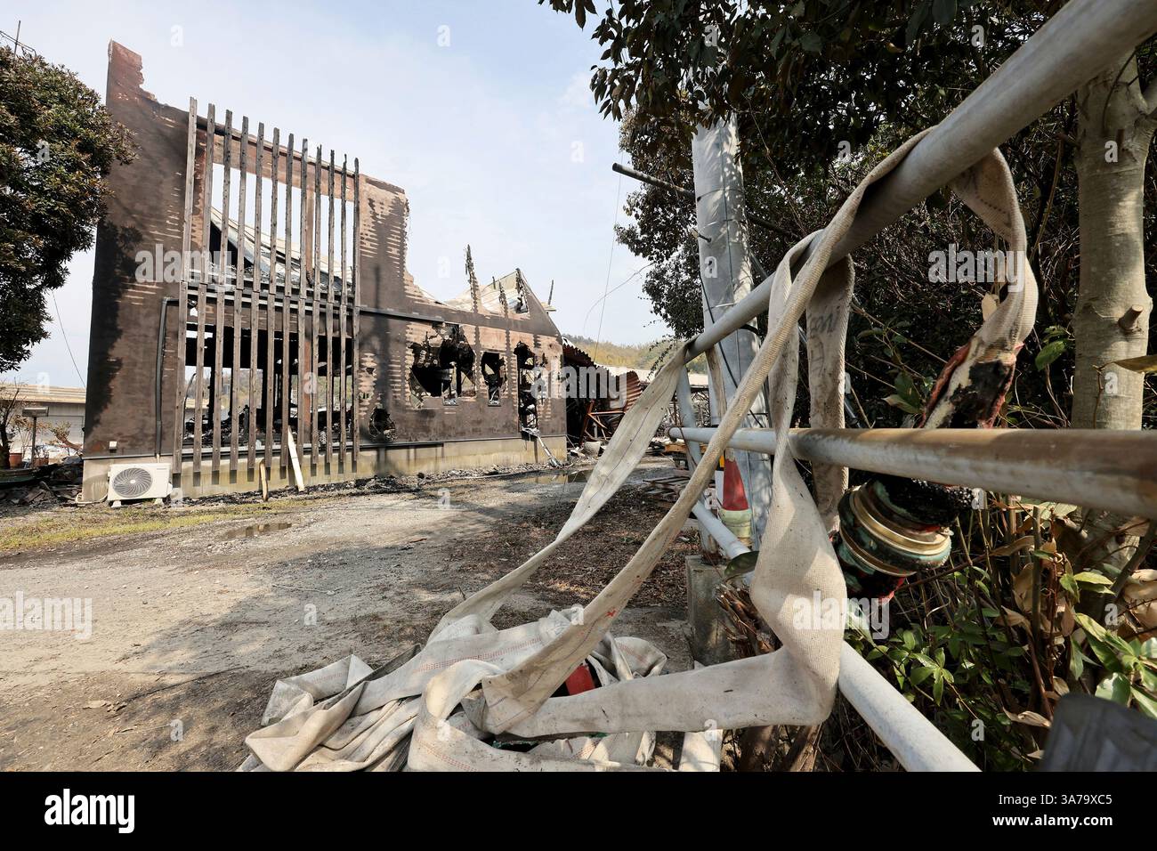 A photo shows a building completely burned down due to the spread of a ...
