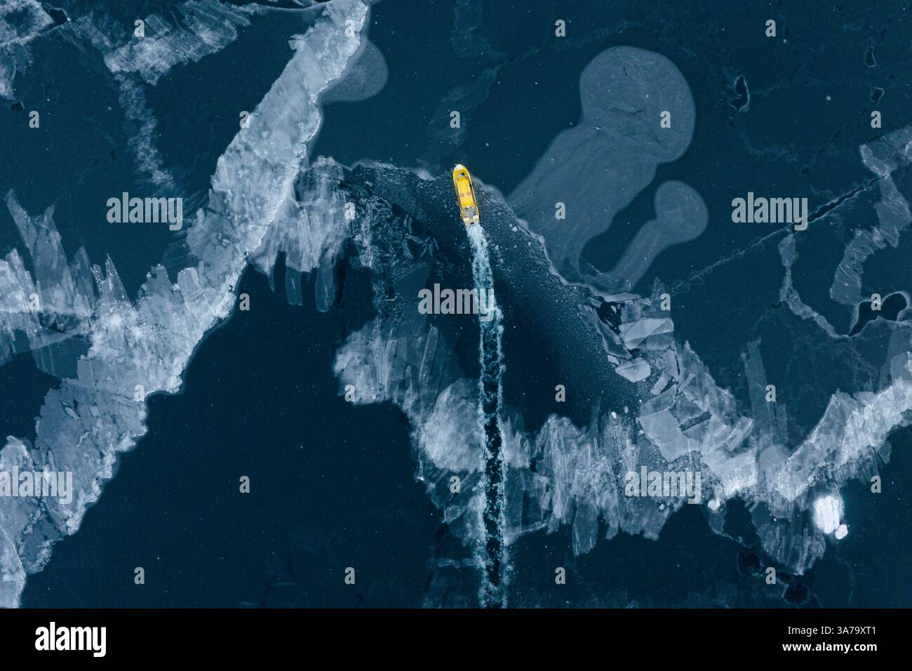 A boat travels though a frozen sea inlet outside of Nuuk, Greenland ...