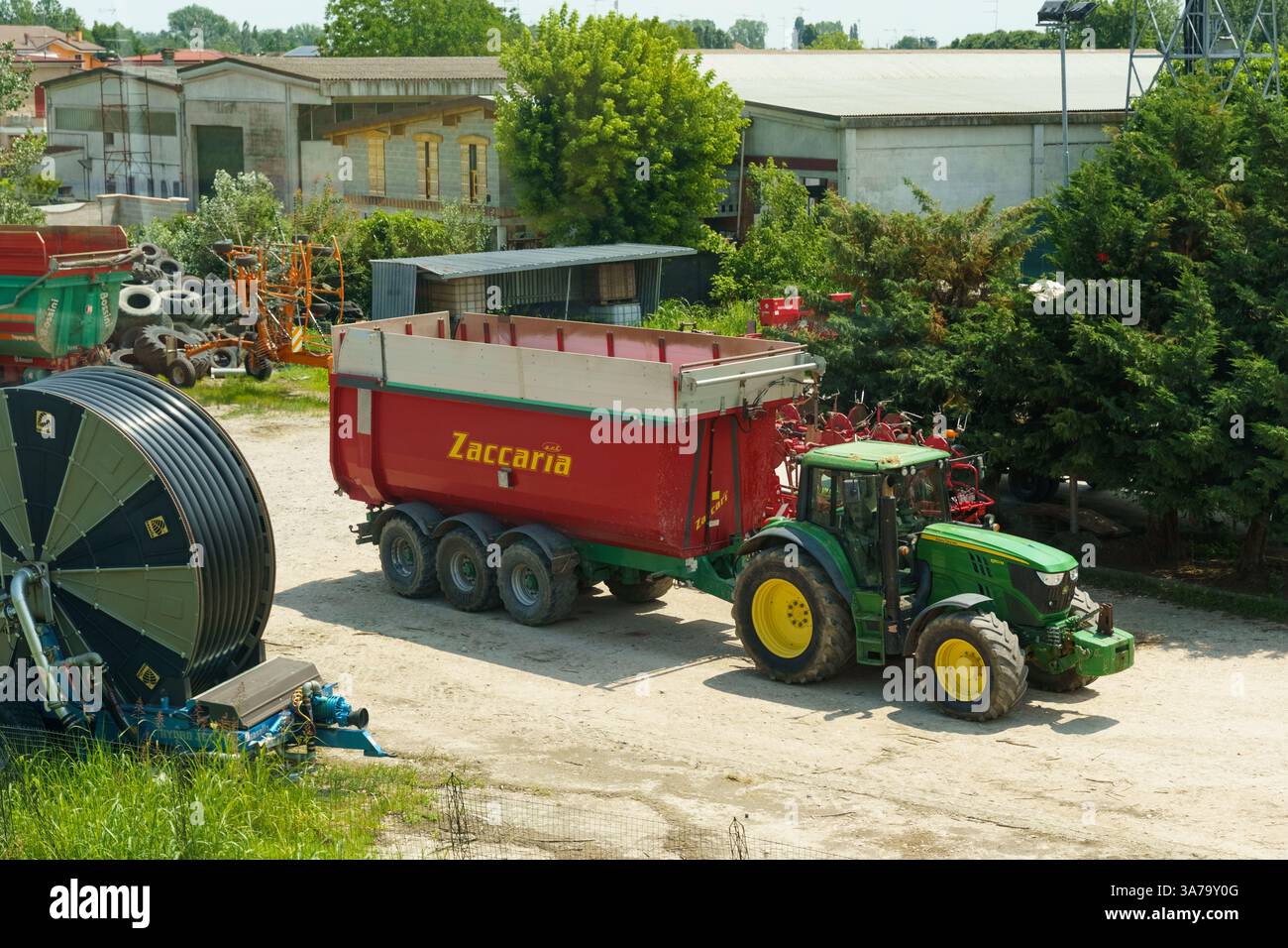 Suzzara, Italy - June 14, 2023: A green tractor moves through a rural ...
