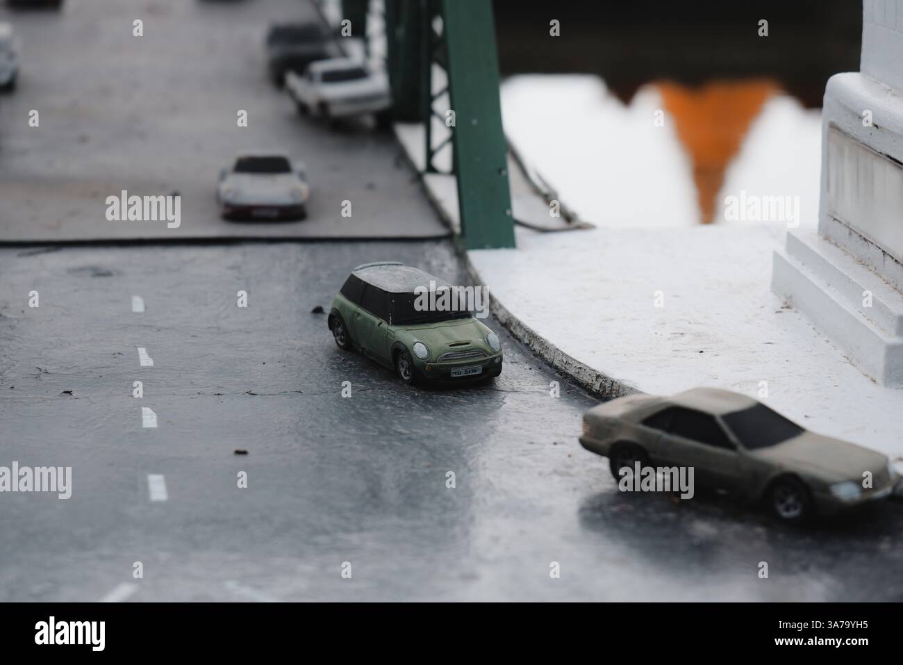 Miniature Cityscape Featuring Toy Cars on a Detailed Roadway, Bridge ...