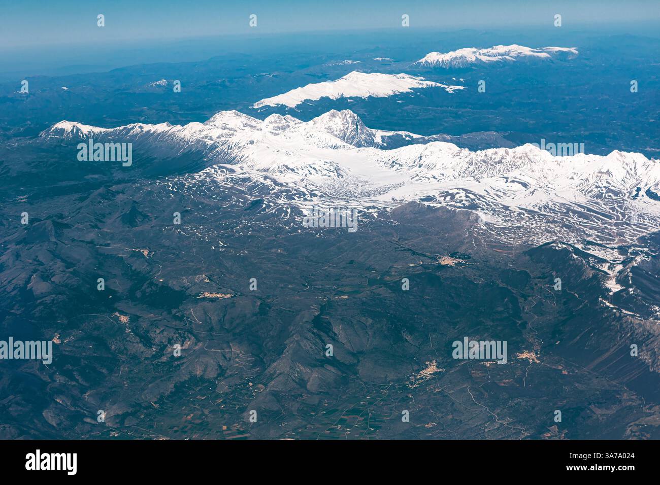 Aerial view of snowy mountain peaks contrasted with rugged, showcasing ...