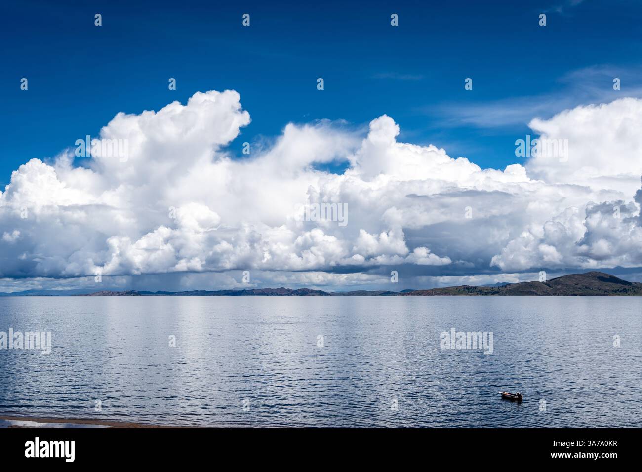 A peaceful view of Lake Titicaca from Llachon, Peru, with deep blue ...