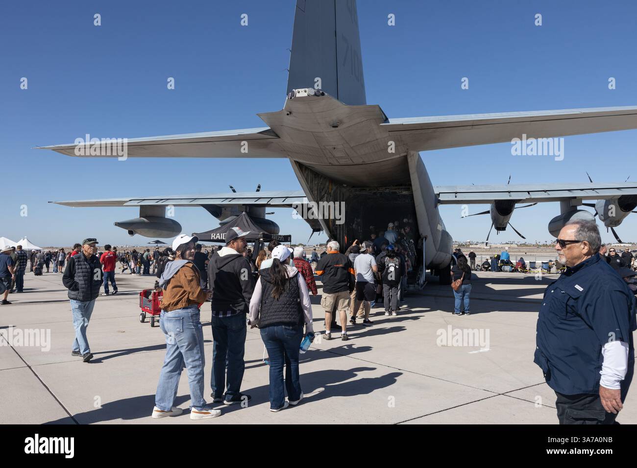 People in attendance wait in line to see inside the U.S. Marine Corps C ...
