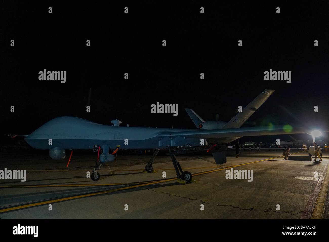 An MQ-9 Reaper armed with Hellfire missiles sits in the live ordnance ...