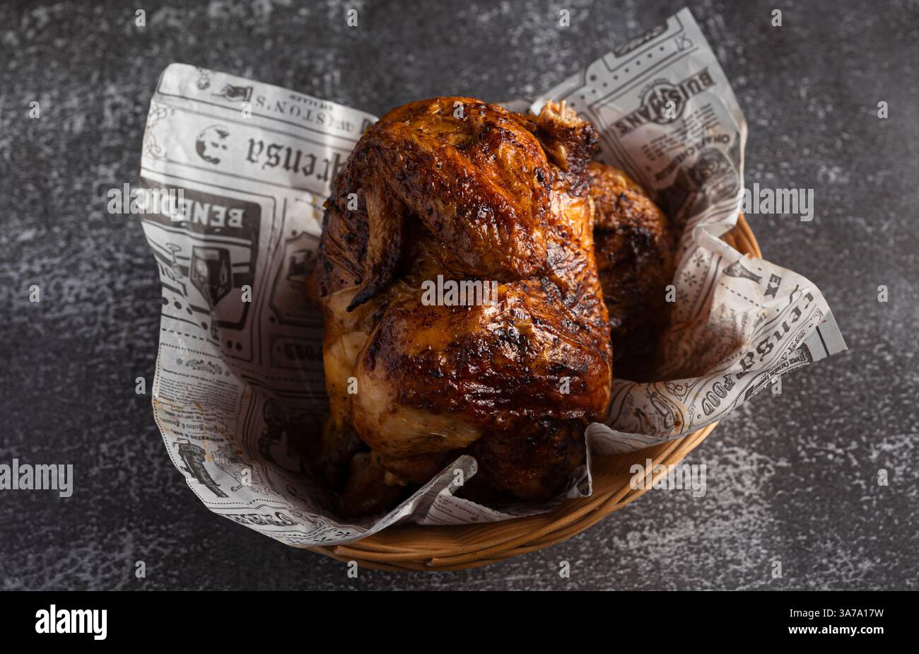 Delicious whole roasted chicken resting in a wicker basket lined with ...