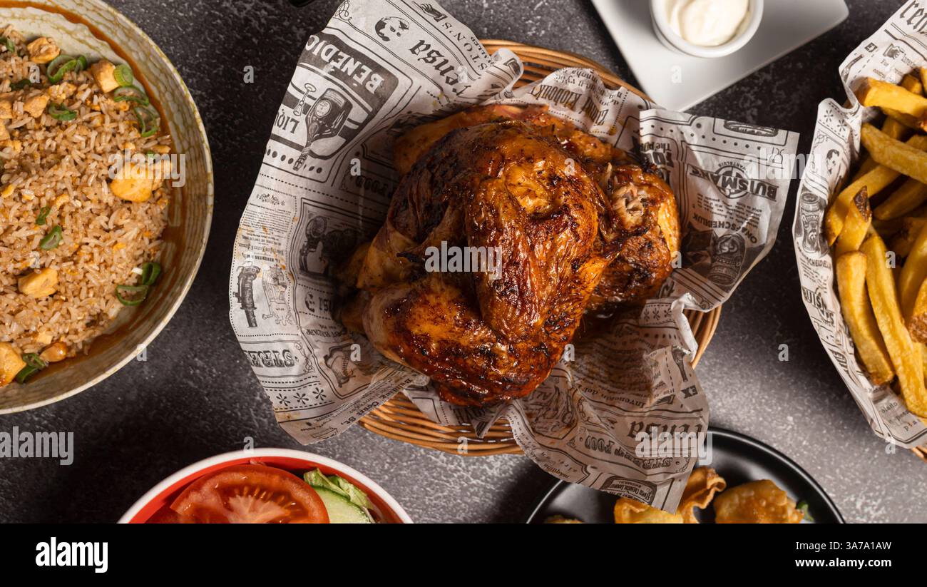 Overhead view of a roasted chicken served with various side dishes ...