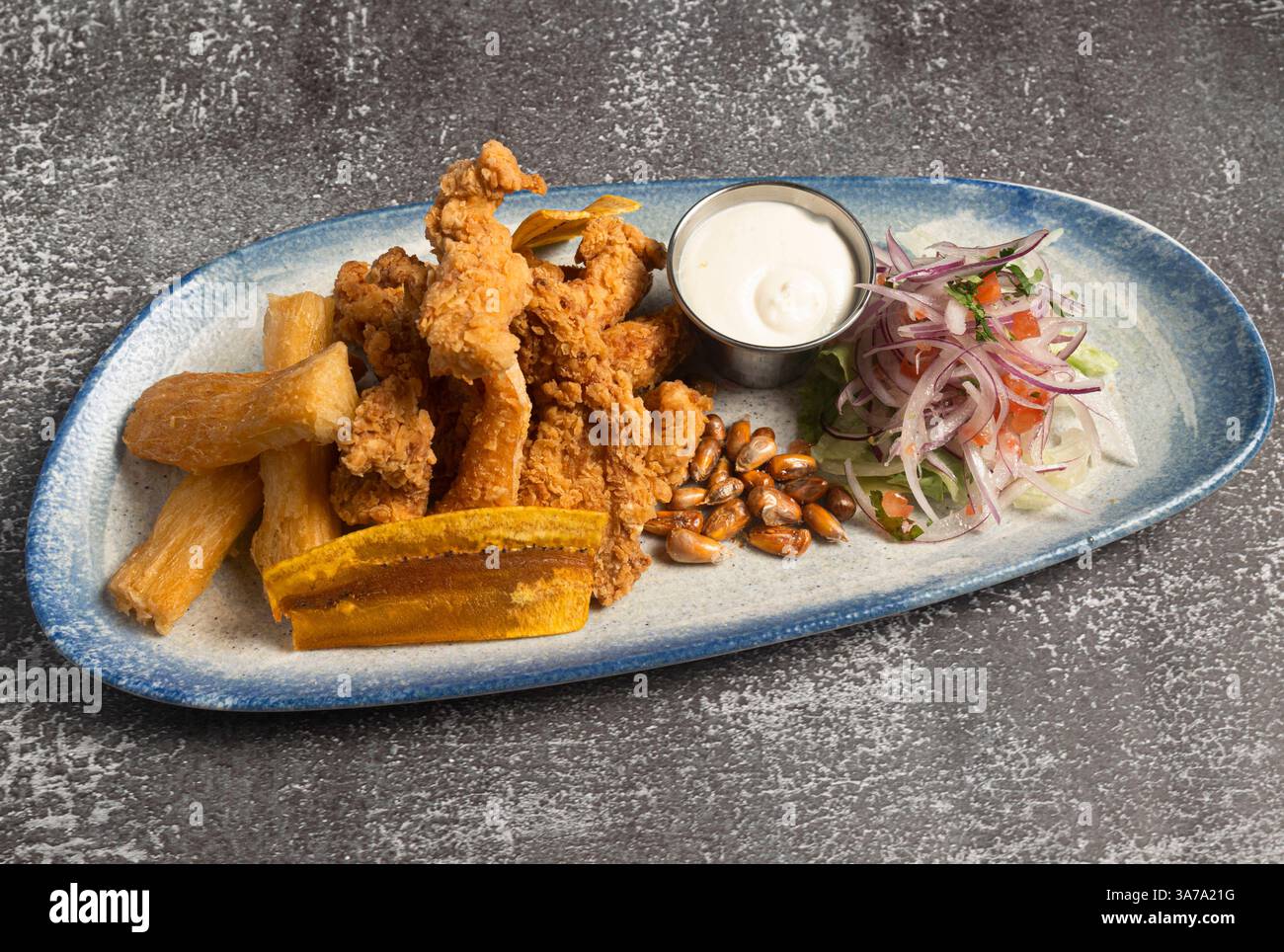 Delicious fried chicken strips served with yuca, fried plantains ...