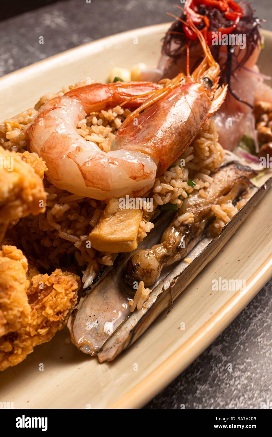 Tantalizing seafood platter presents grilled razor clams, fried chicken ...
