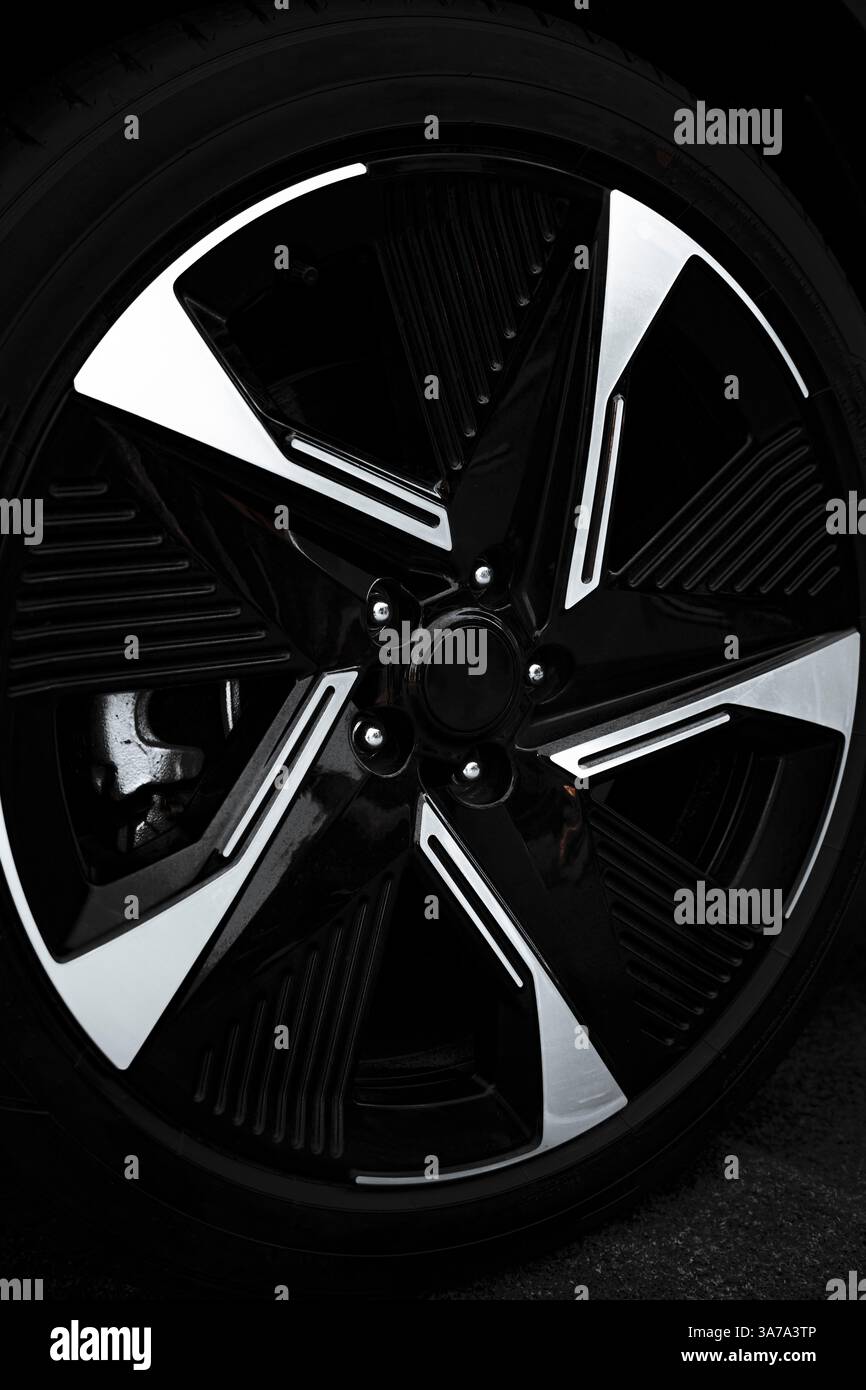 A stunning black luxury car wheel with a beautifully designed alloy rim ...