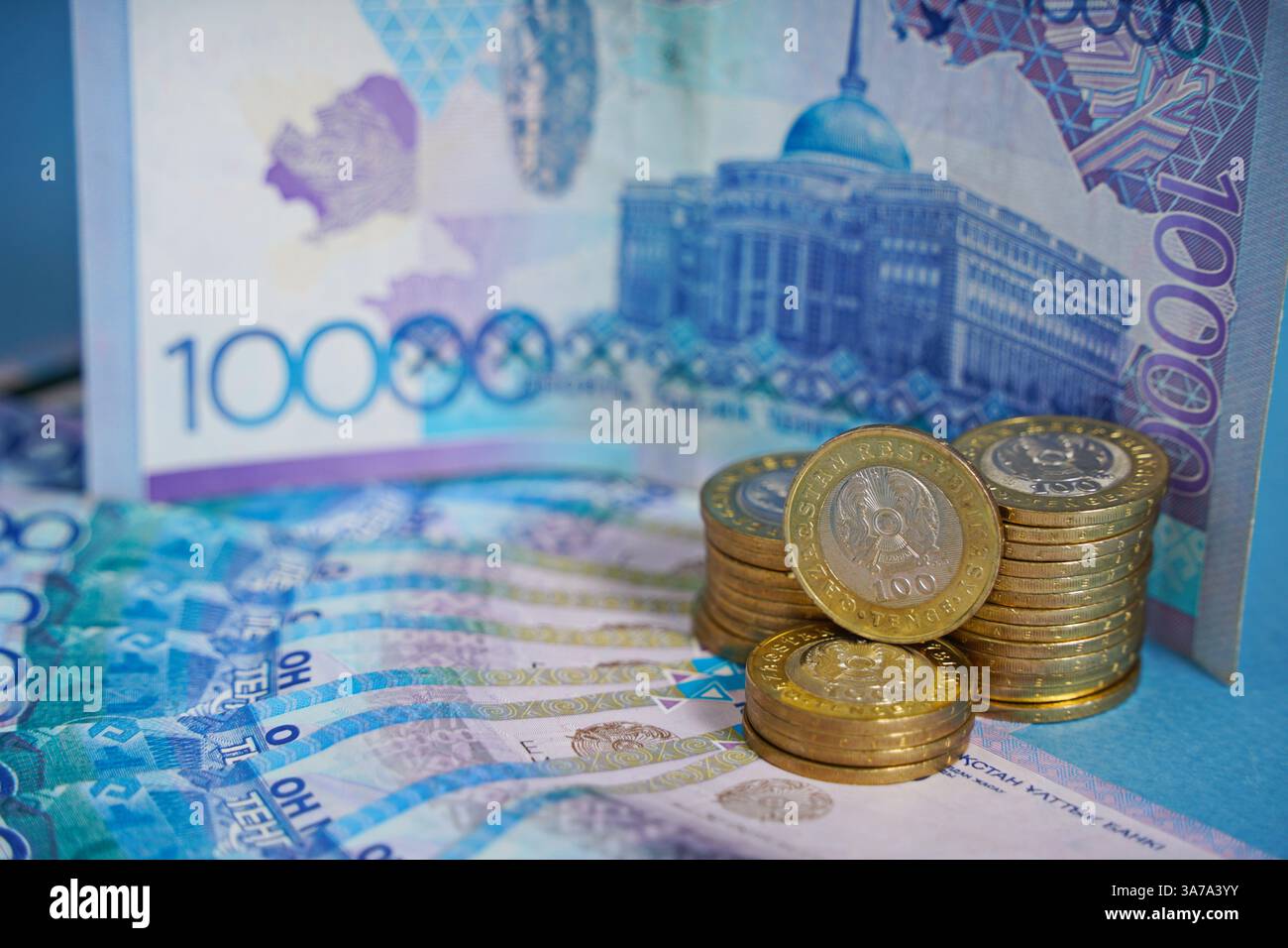 Coins, tenge banknotes on the background of an oil rocking chair and ...