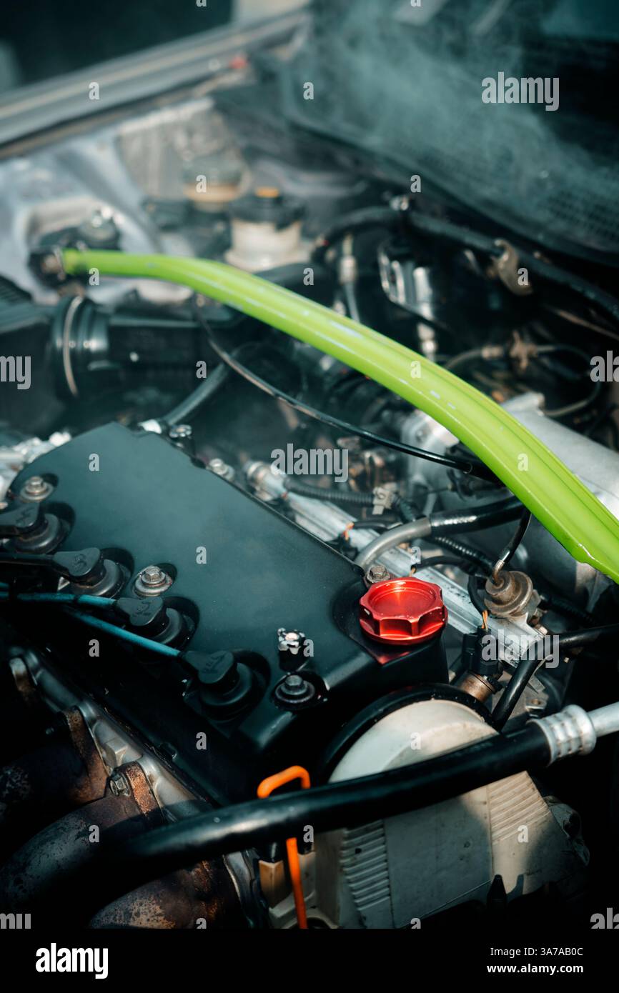 A high-performance sports car engine emitting smoke, showcasing ...