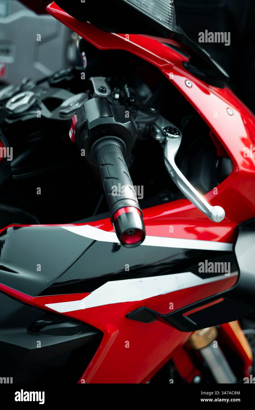 A tight shot of a red heavy bike’s handle and accelerator, showcasing ...