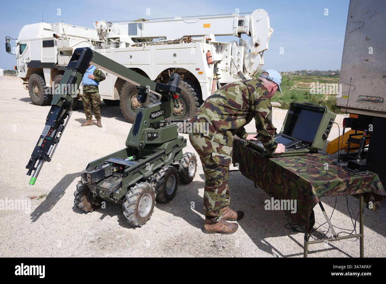 A soldier demonstrates a bomb disposal robot at Camp Shamrock near the ...