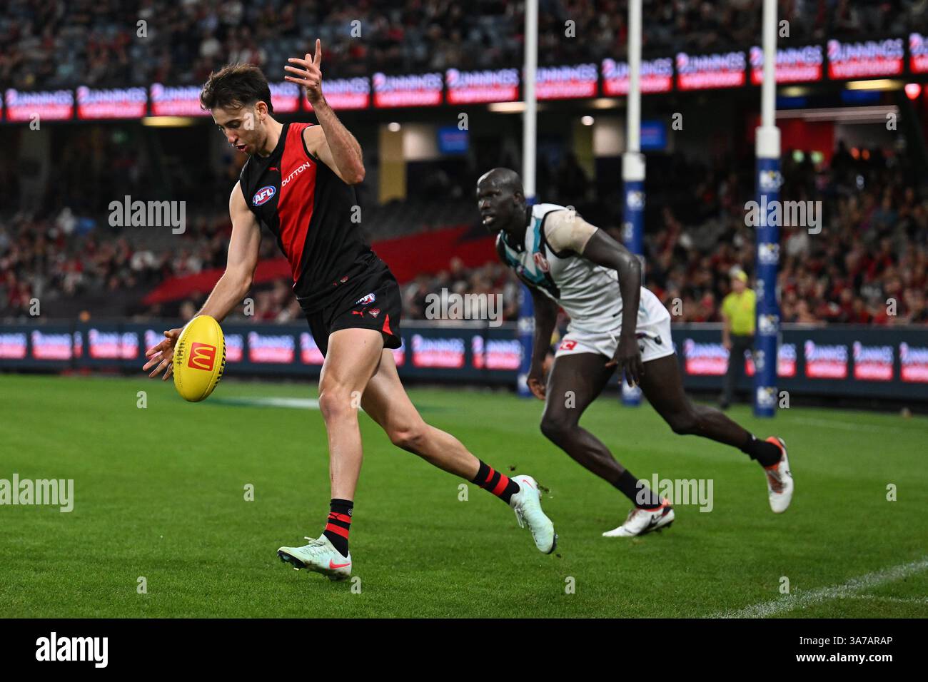 Melbourne, Australia. 27th Mar, 2025. Nic Martin of Essendon (left ...