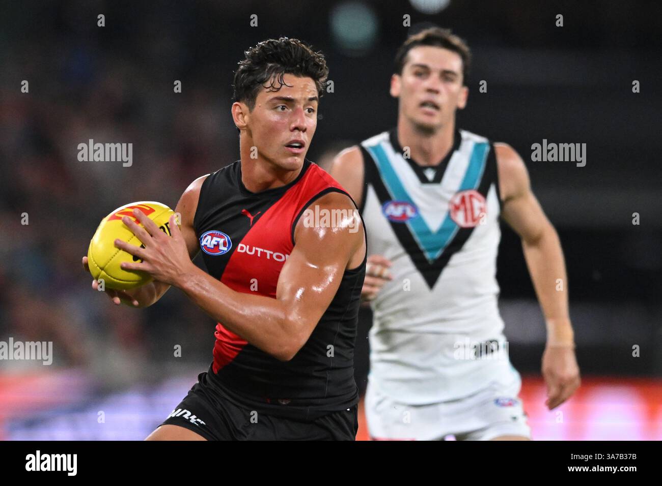 Melbourne, Australia. 27th Mar, 2025. Jye Caldwell of Essendon (left ...