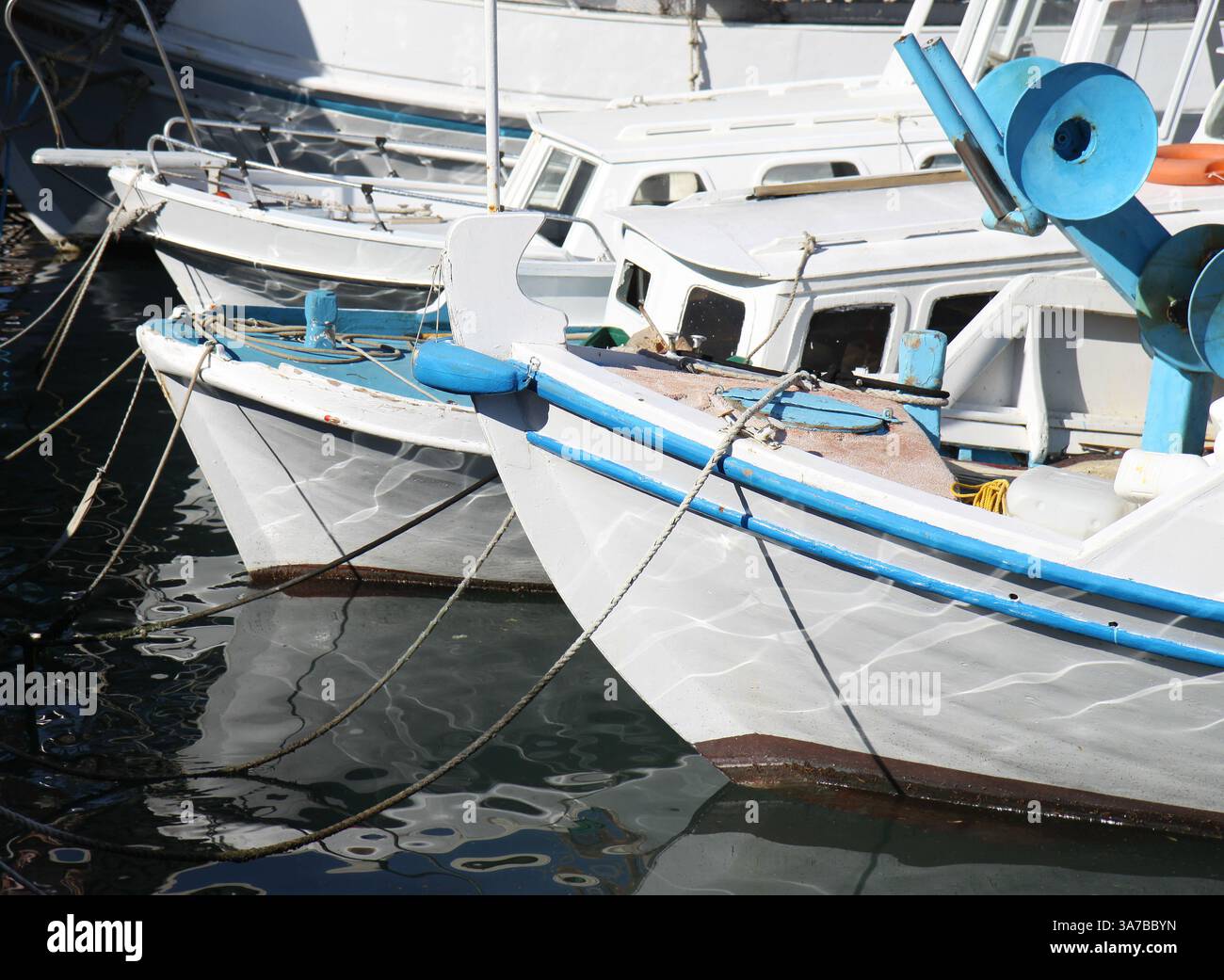 Traditional Greek Wooden Fishing Boats with Reflections moored in ...