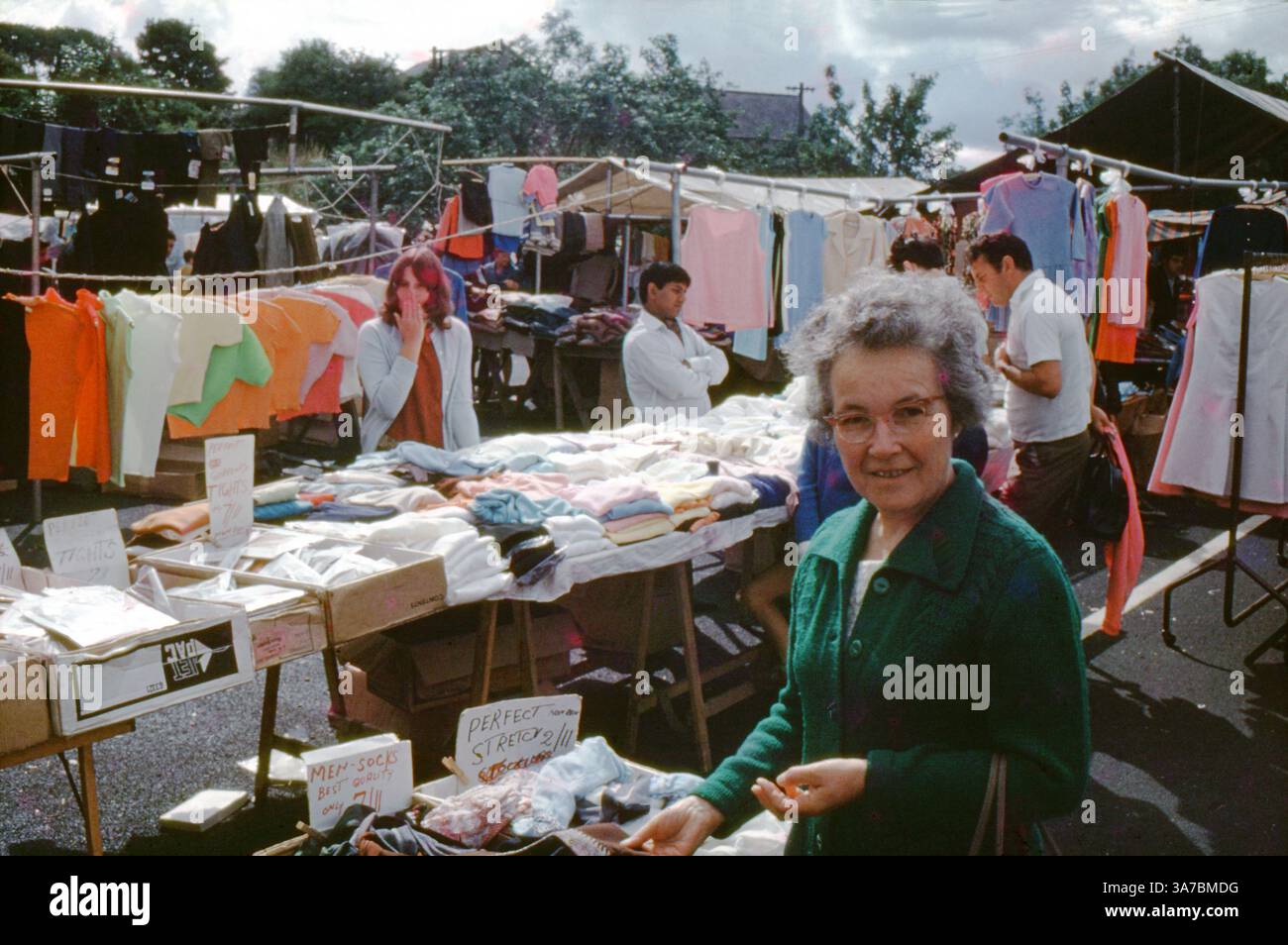 A lively snapshot from a bustling 1960s British street market, captured ...