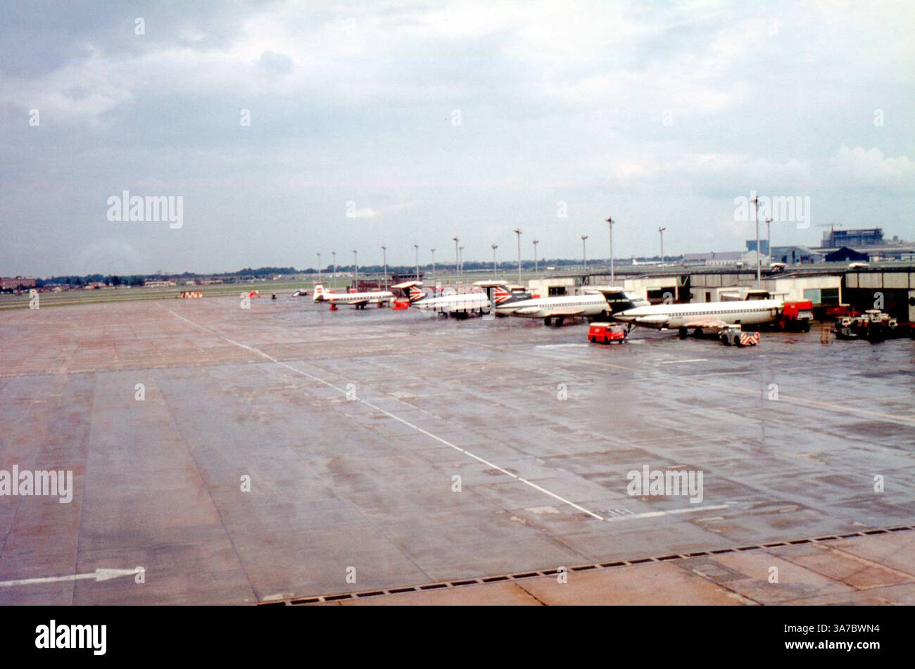 A view of Heathrow Airport, London, during the 1970s, showing a line of ...