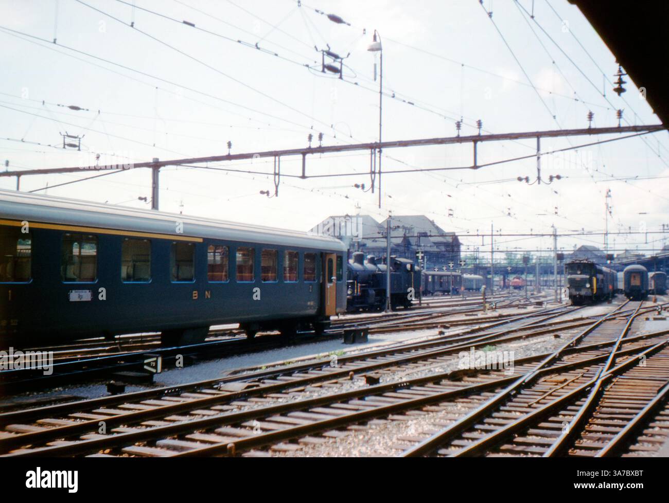 A busy scene at Basel train station in Switzerland during the 1960s ...