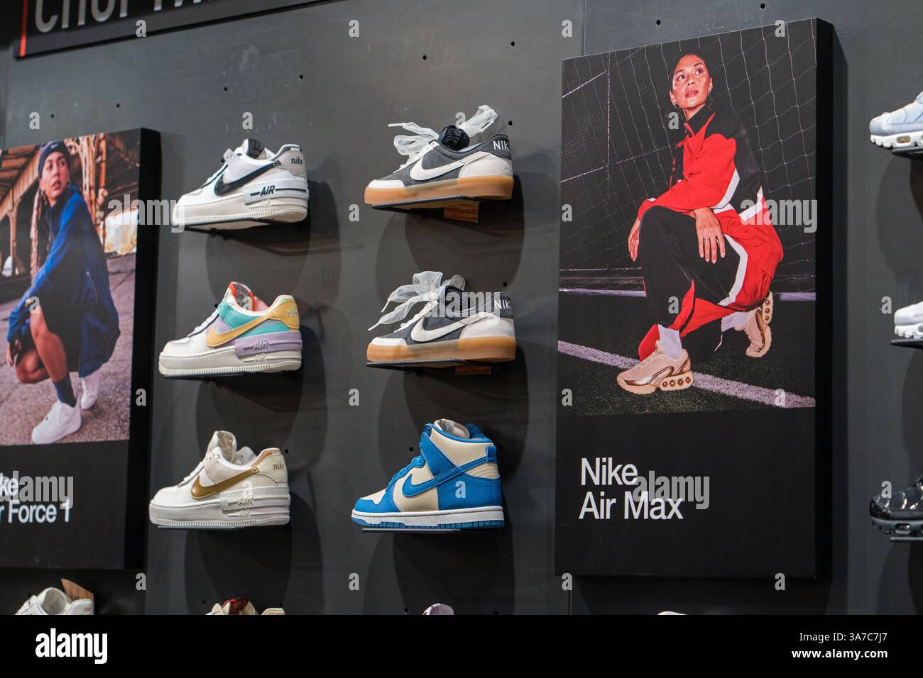 Various models of women's Nike sports shoes displayed at Nike store ...