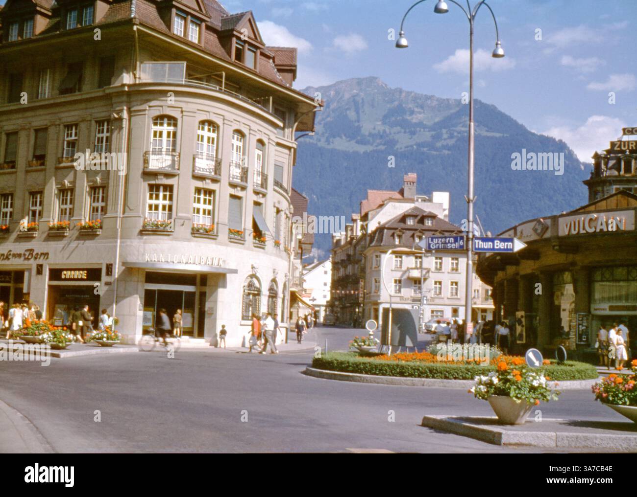 A vibrant 1960s street scene from Interlaken, Switzerland, captured on ...