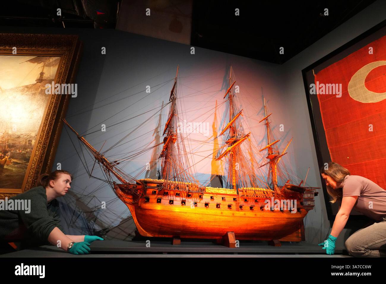Museum technicians adjust a model of a 74-gun third rate warship, by ...