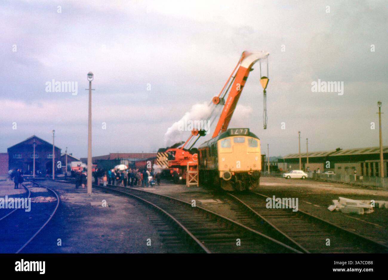 A British Rail Class 25 diesel locomotive stands next to a steam ...