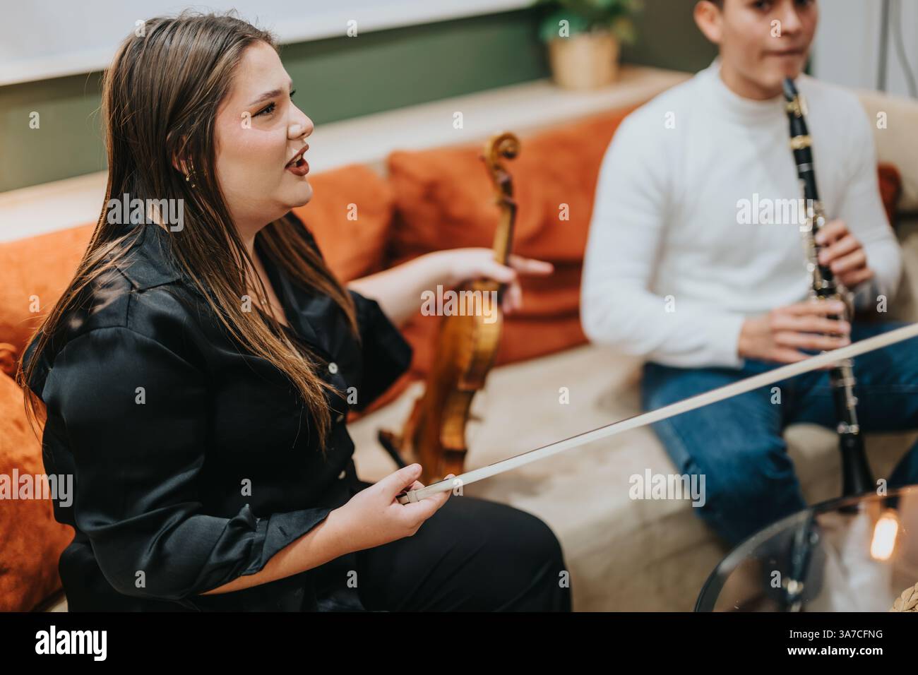 Two young musicians playing violin and clarinet during a music session ...