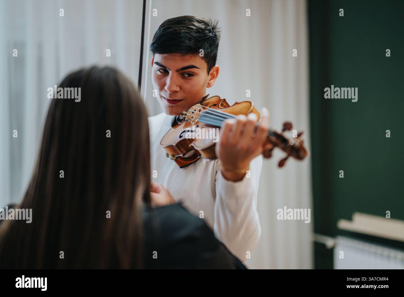 Person learning to play violin with teacher in a music studio Stock ...