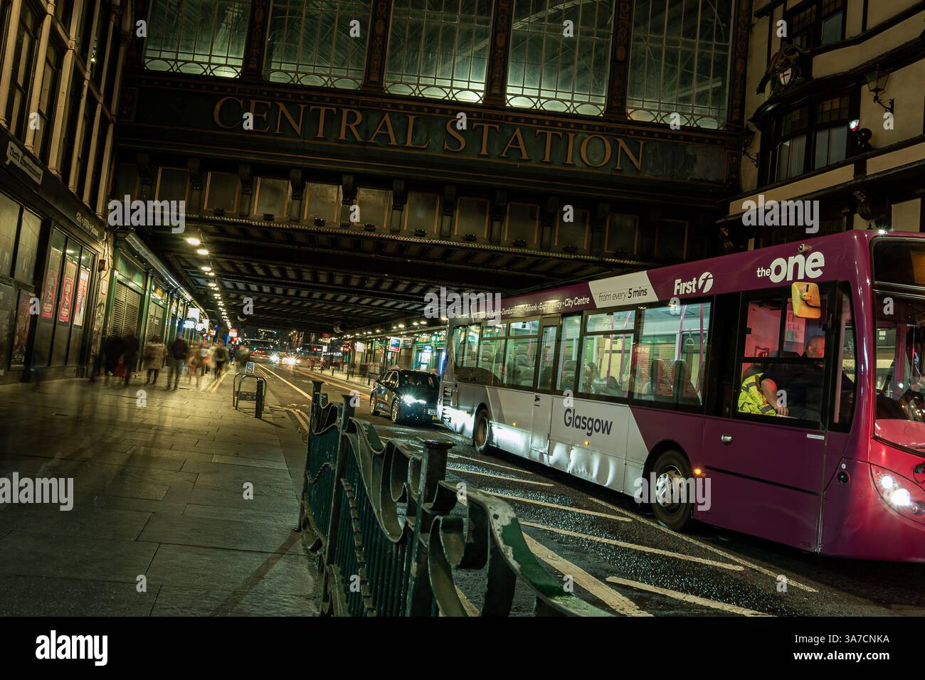 Night scene at Glasgow Central Station featuring a First Bus service ...