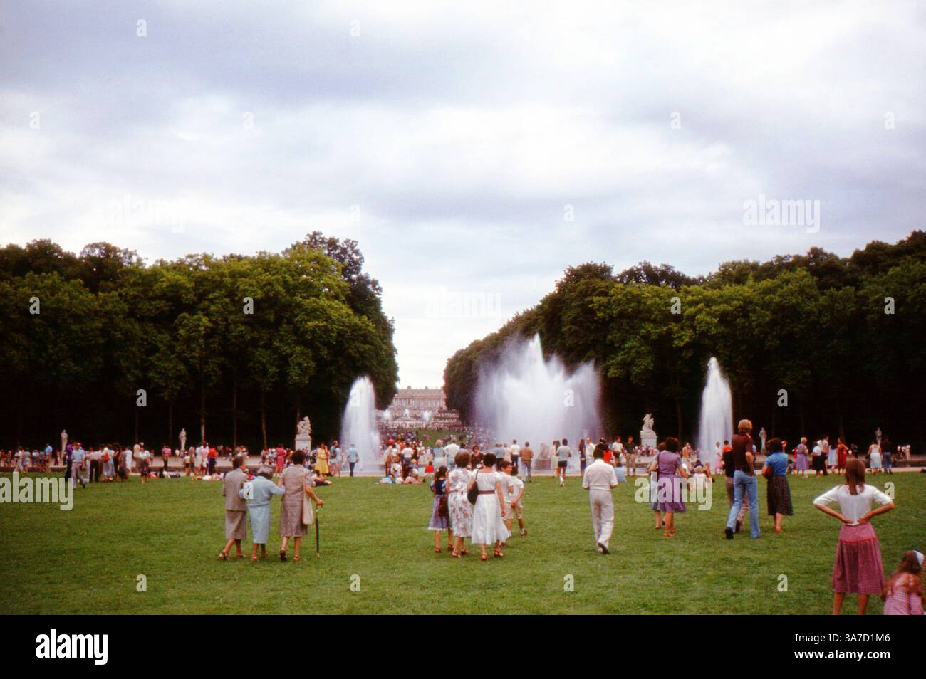 Visitors gather around the dramatic fountains of the Bassin d’Apollon ...