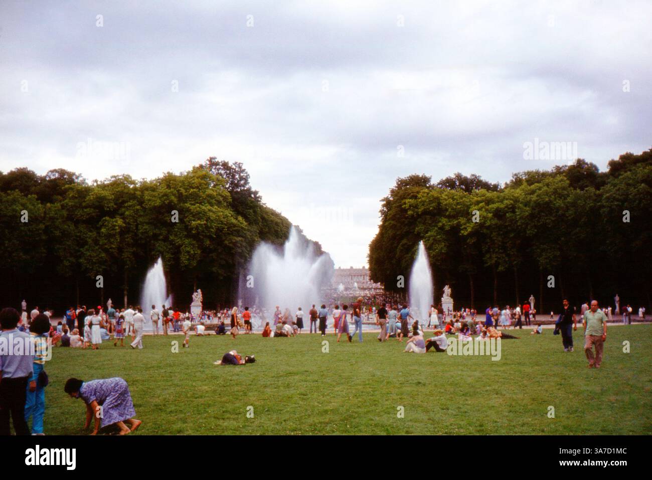 Visitors gather around the dramatic fountains of the Bassin d’Apollon ...