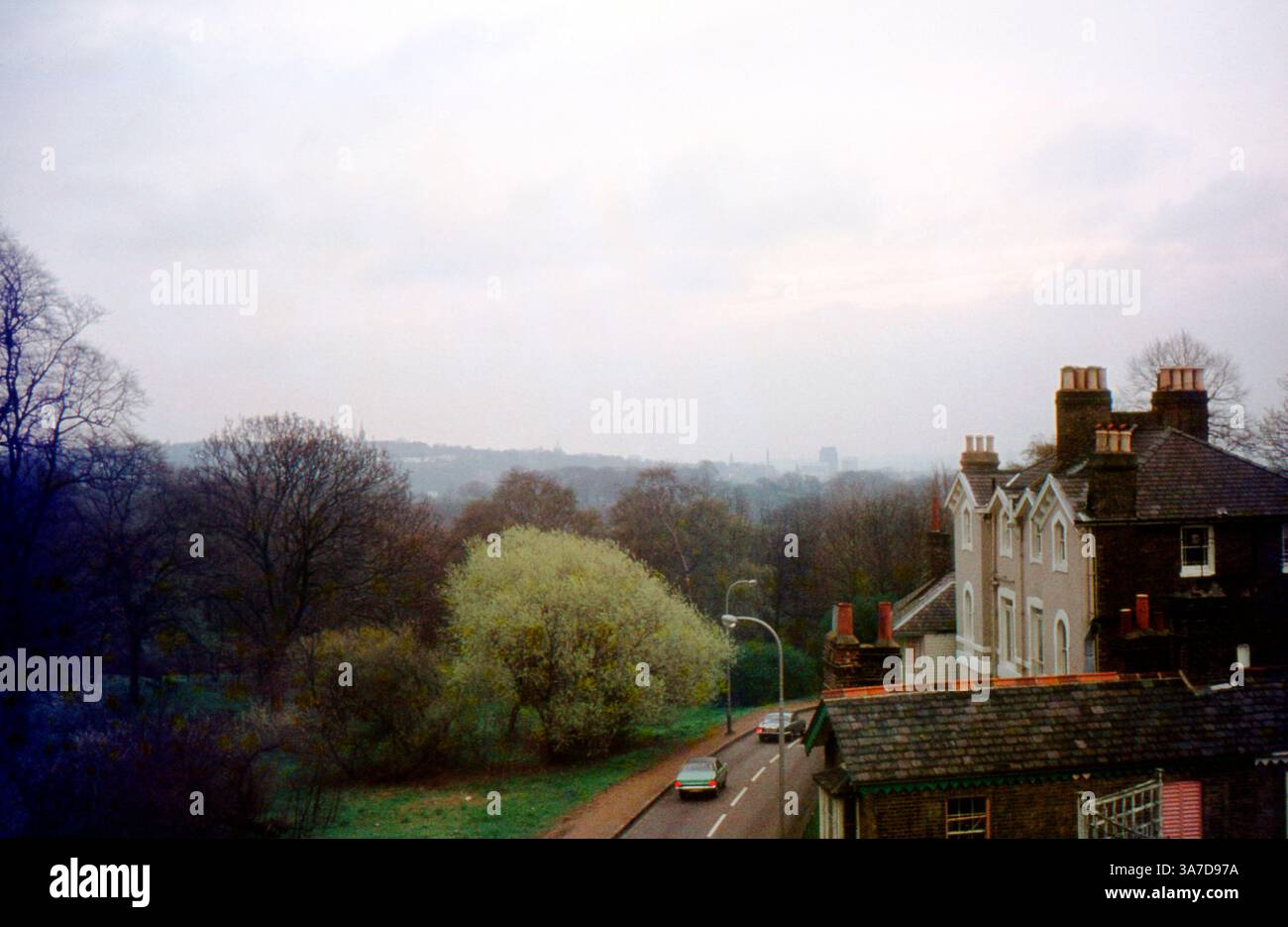 A quiet suburban road near London curves past Victorian houses and ...