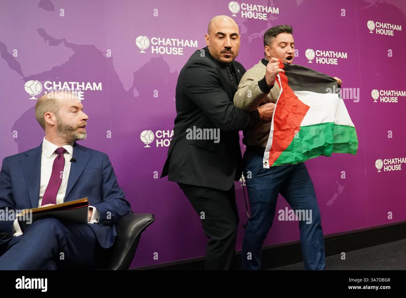 A protester interrupts Business Secretary Jonathan Reynolds delivering ...