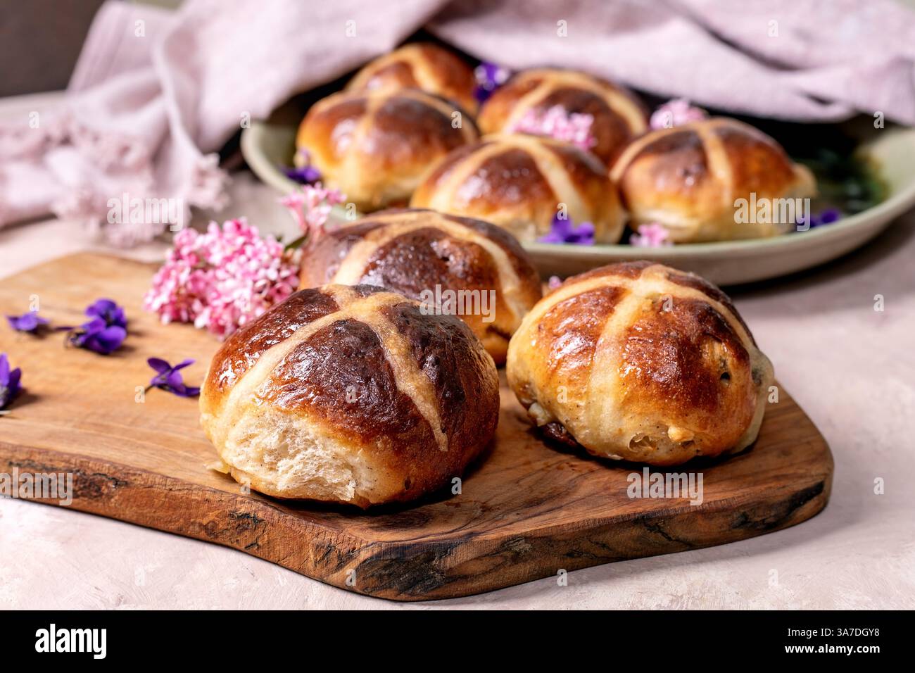 Traditional hot cross buns on wooden board. Easter baking with spices ...