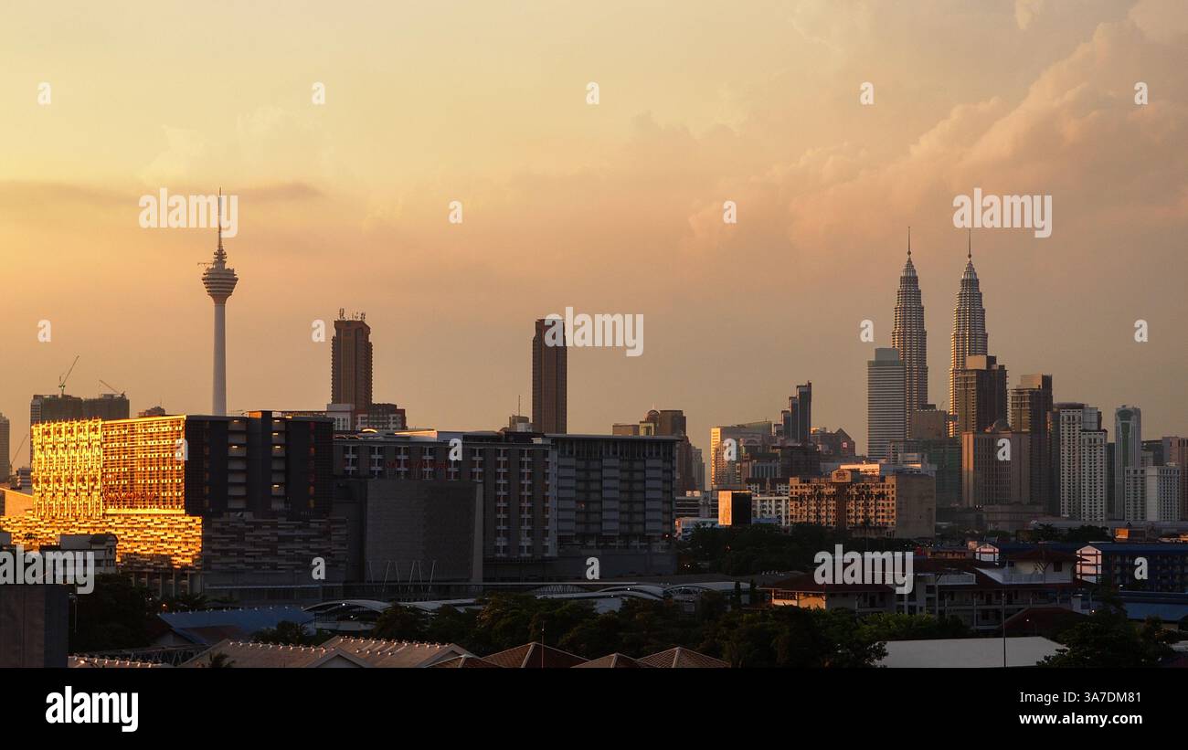 A view of Menara Kuala Lumpur and Petronas Twin Towers during golden hour before sunset Stock ...