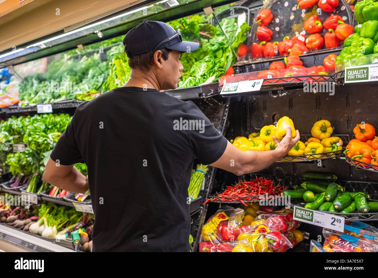A man shopping to buy vegetable in the supermarket. Fresh organic ...