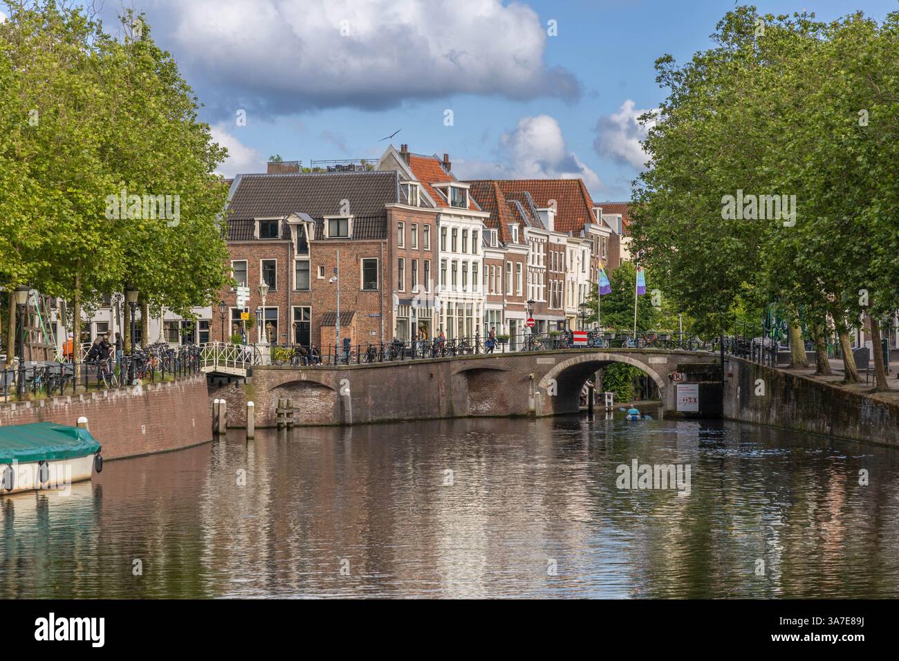 River de Vecht Utrecht with green trees, old brick buildings and a arch ...