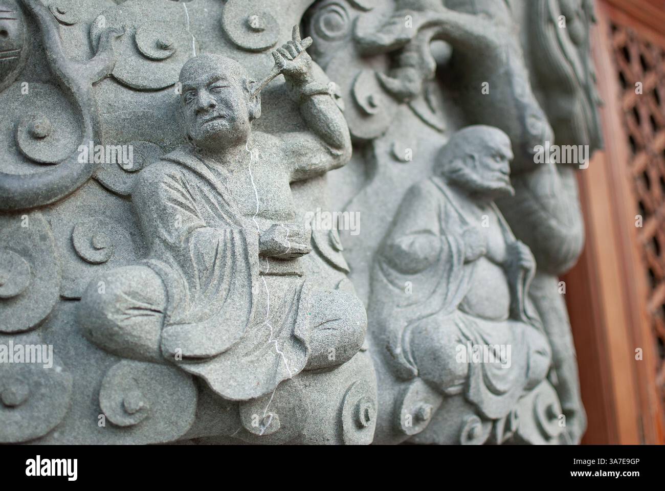 Close up shot of Chinese statue of man with a stick in his ear Stock ...