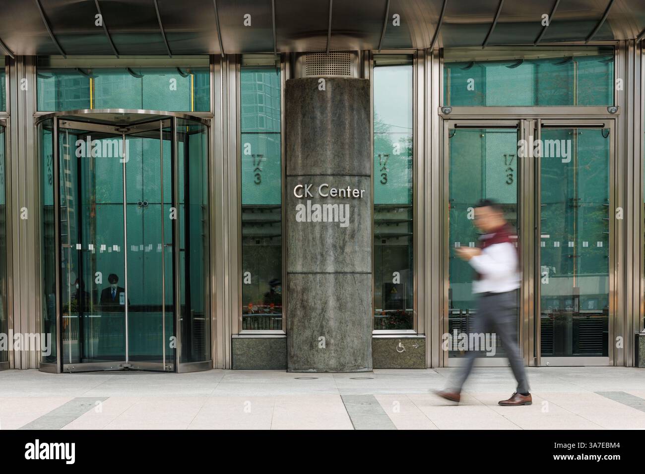 A man walks past Cheung Kong centre, the headquarters of CK Hutchison ...