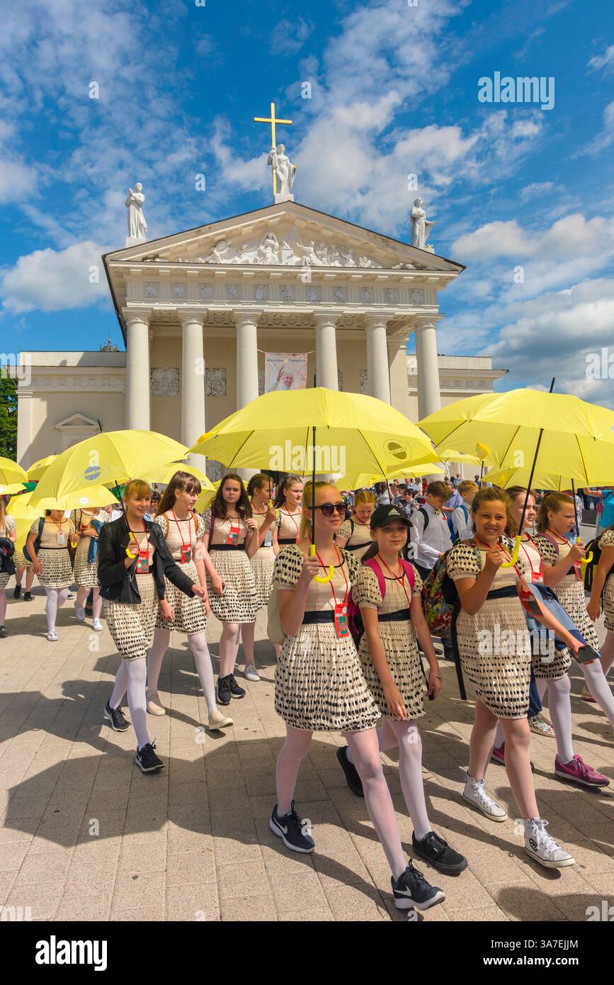 Young people parade, view of young women parading with yellow umbrellas ...