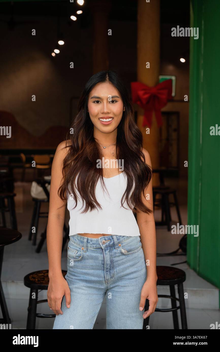 Portrait of beautiful young Asian woman standing in restaurant Stock Photo - Alamy
