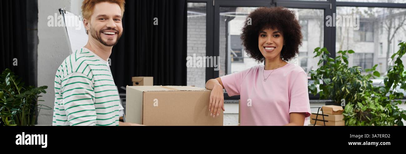 Two happy individuals pack boxes, getting ready to move into a new ...